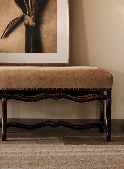 Upholstered bench on neutral-hued rug.